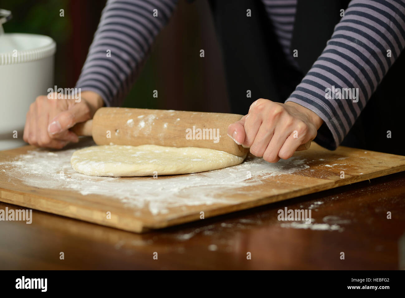 Woman hand making bread with rolling pin on the kitchen Stock Photo - Alamy