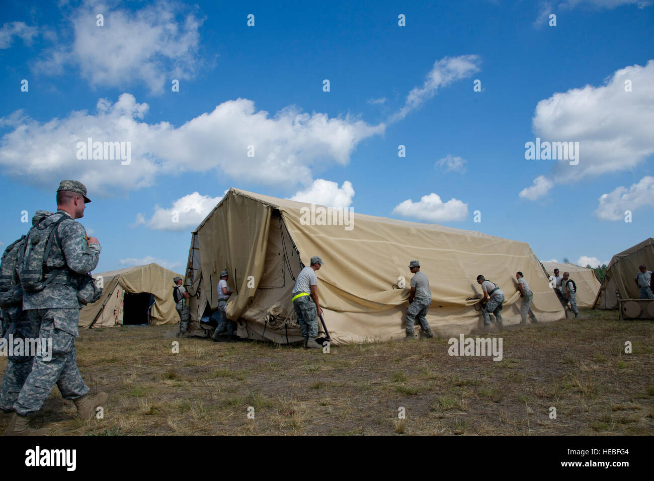 U.S. Air Force Airmen assemble and move an Utilis Compact TM60 Tall ...