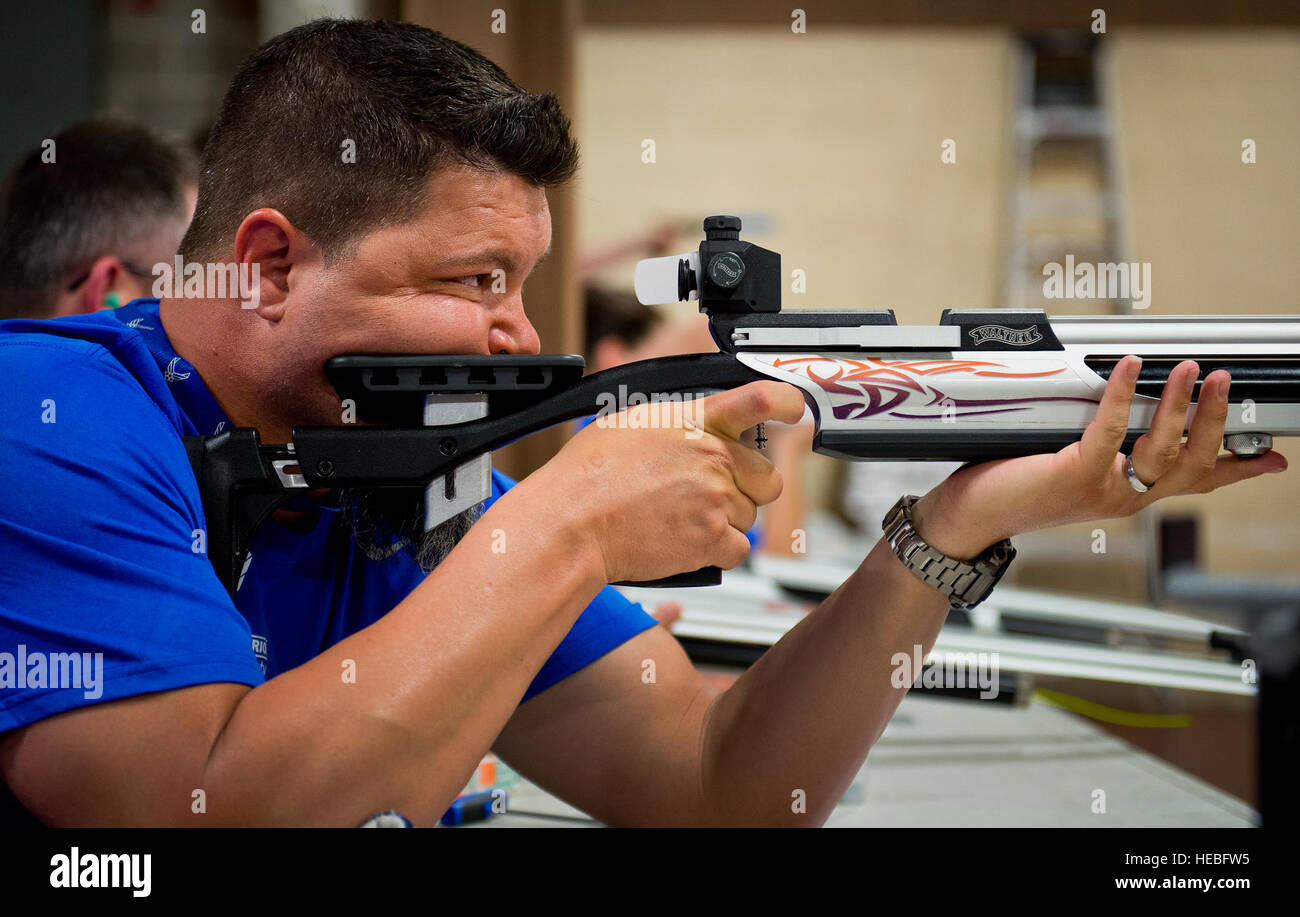 Courtney Hinson, a Warrior Care attendee, aims his rifle downrange ...