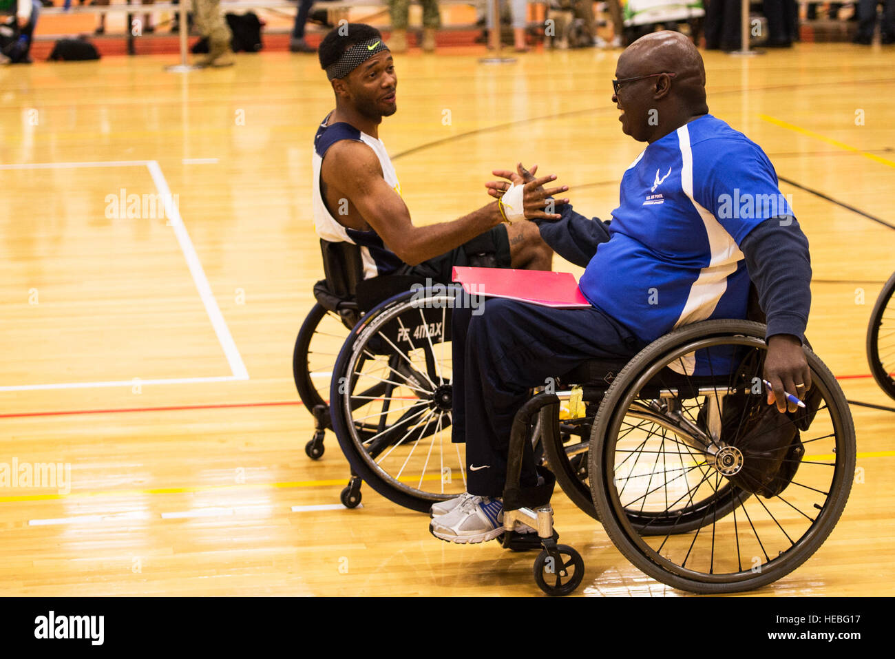 U.S. Navy athlete Angelo Anderson high-fives Air Force coach William ...