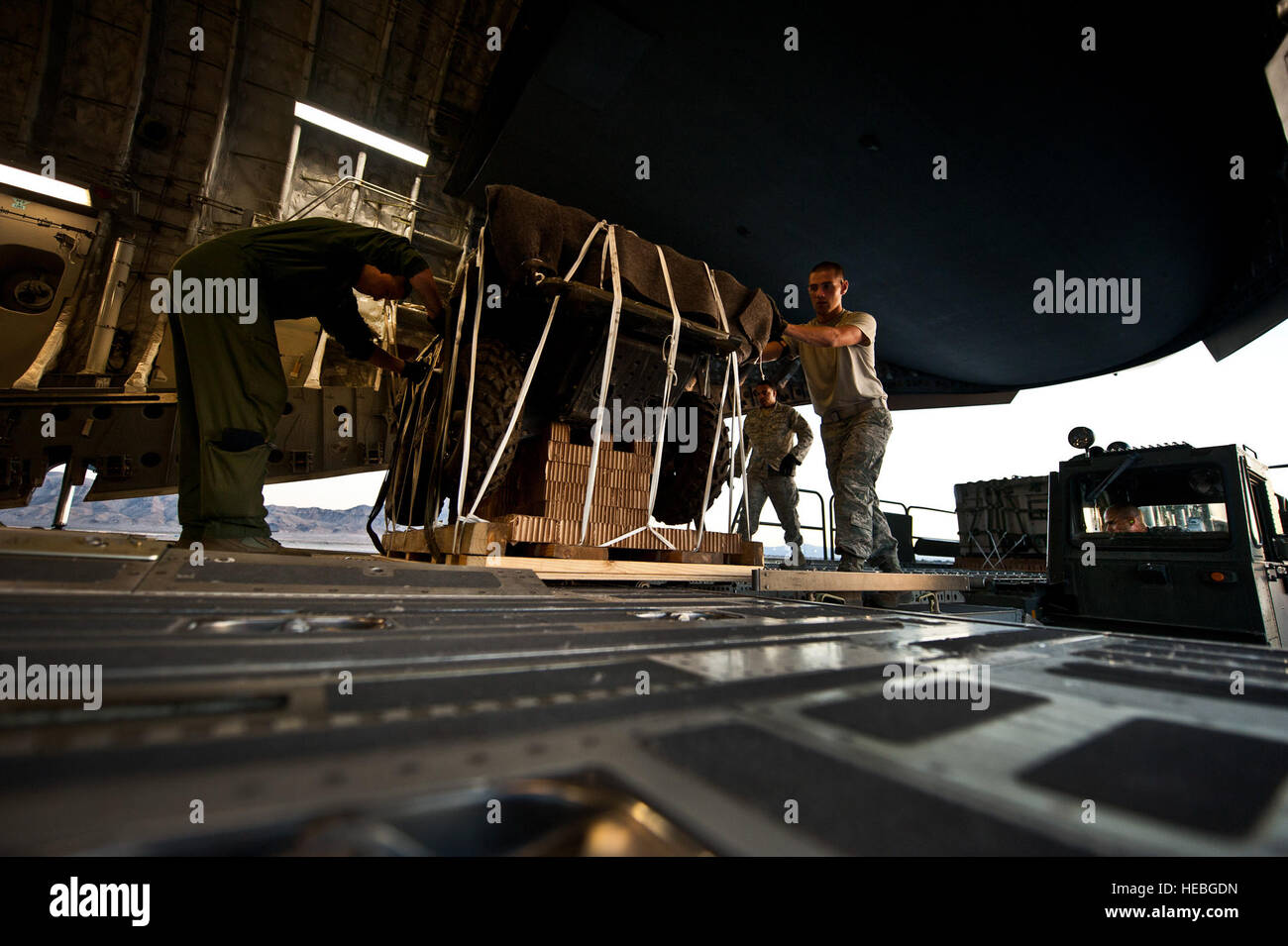 Airmen load cargo onto a C-17 Globemaster at Nellis Air Force Base ...