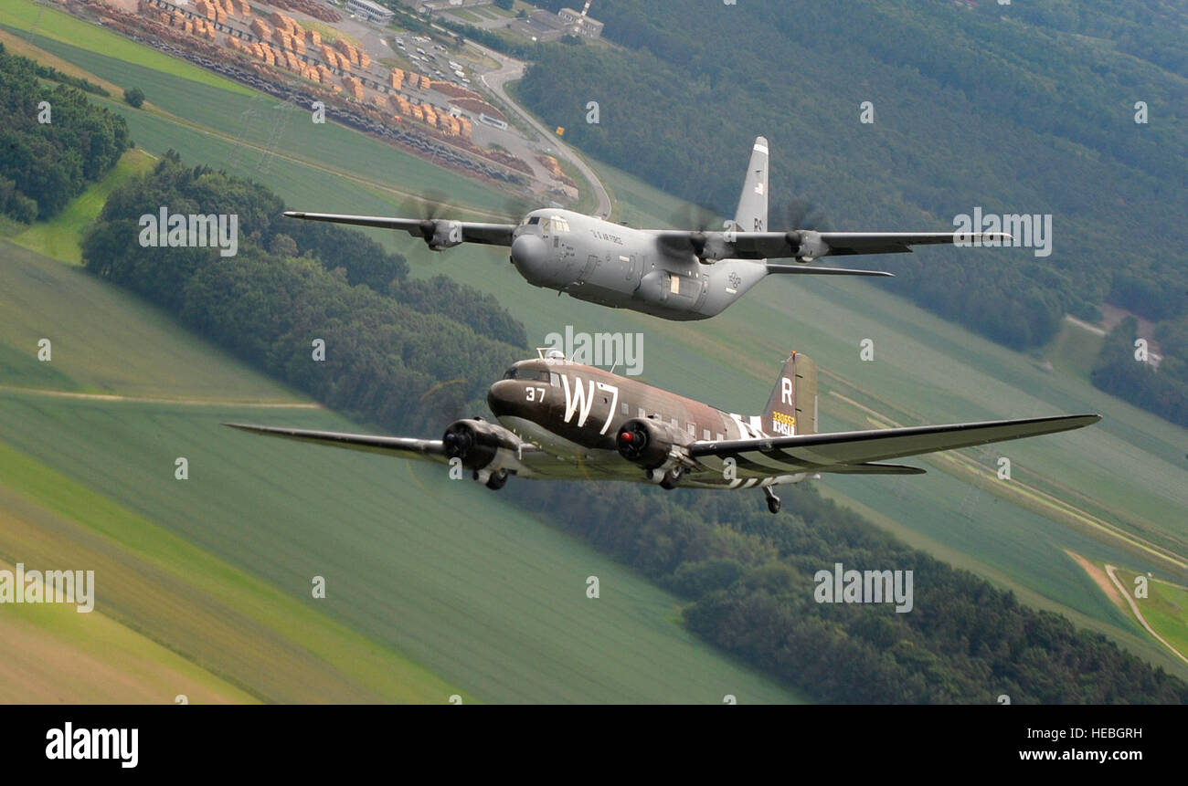A Douglas C-47 Skytrain, known as Whiskey 7, flies alongside a C-130J ...