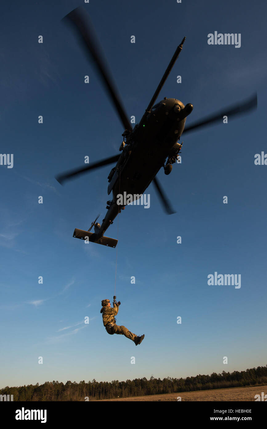 A pararescueman from the 38th Rescue Squadron is hoisted into an HH-60G Pave Hawk Feb. 19, 2015 ...