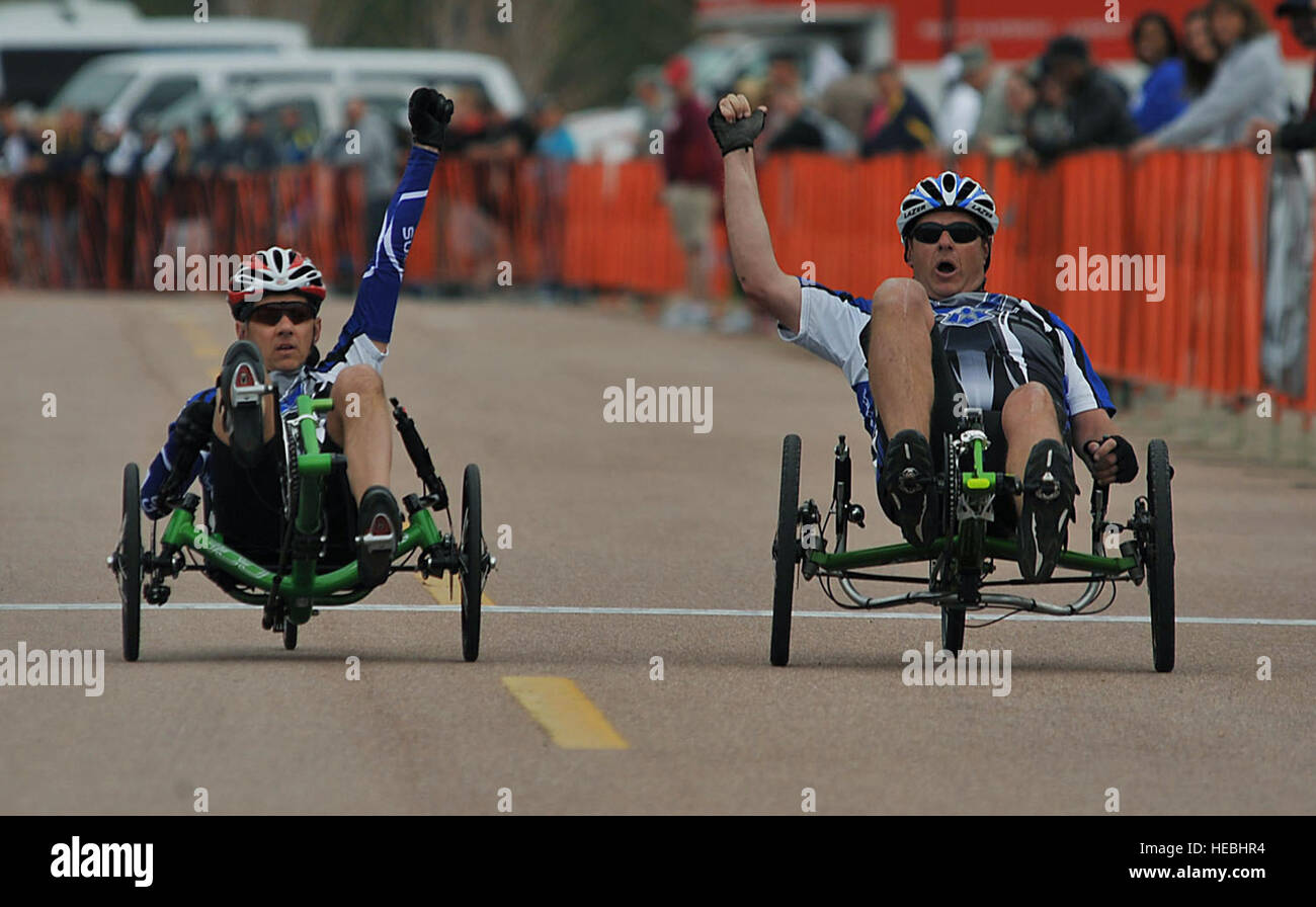 Senior Master Sgt. Mike Sanders (left) and Maj. Scott Bullis raise ...