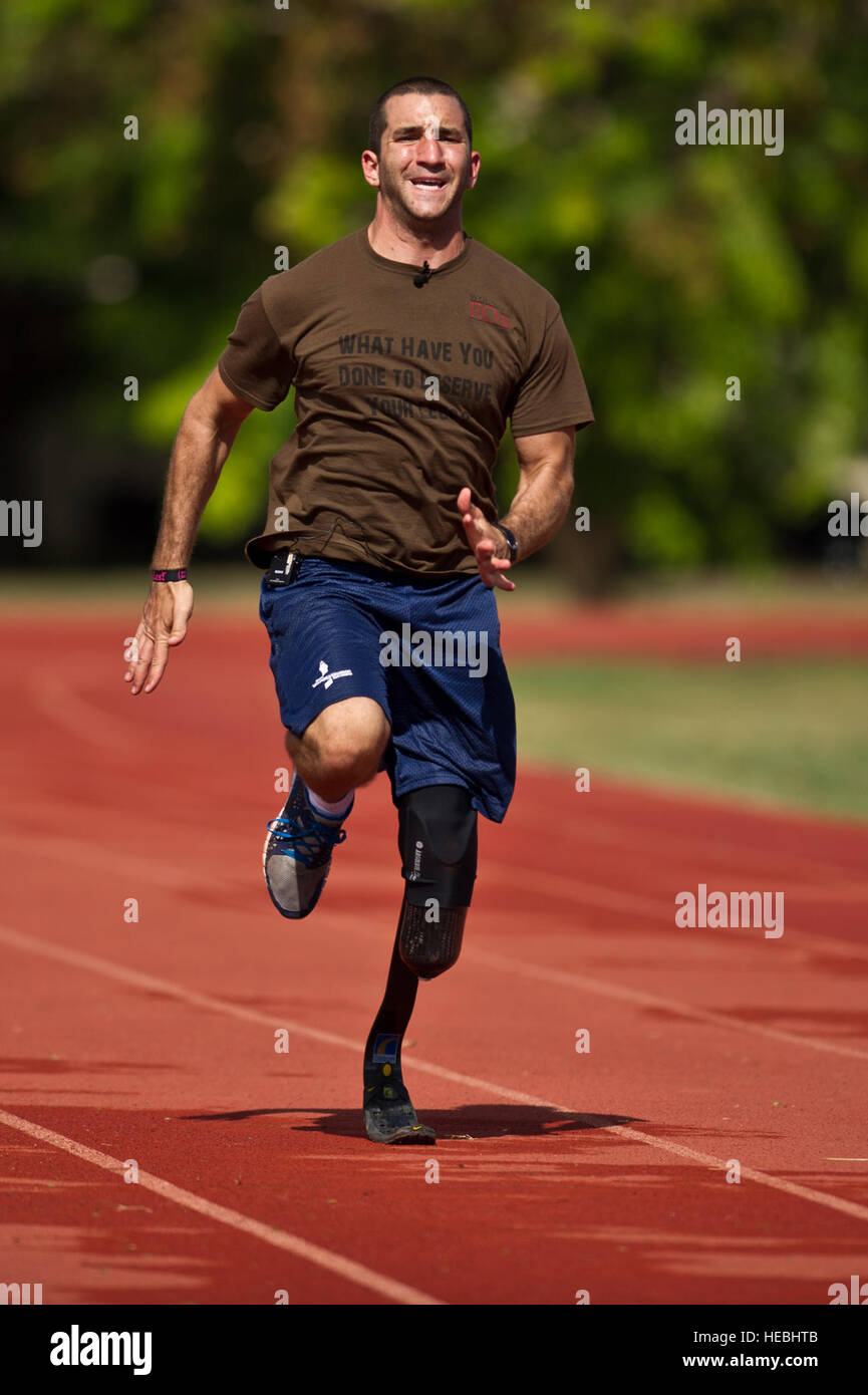 U.S. Navy Petty Officer 3rd Class Redmond Ramos practices the 100-meter ...