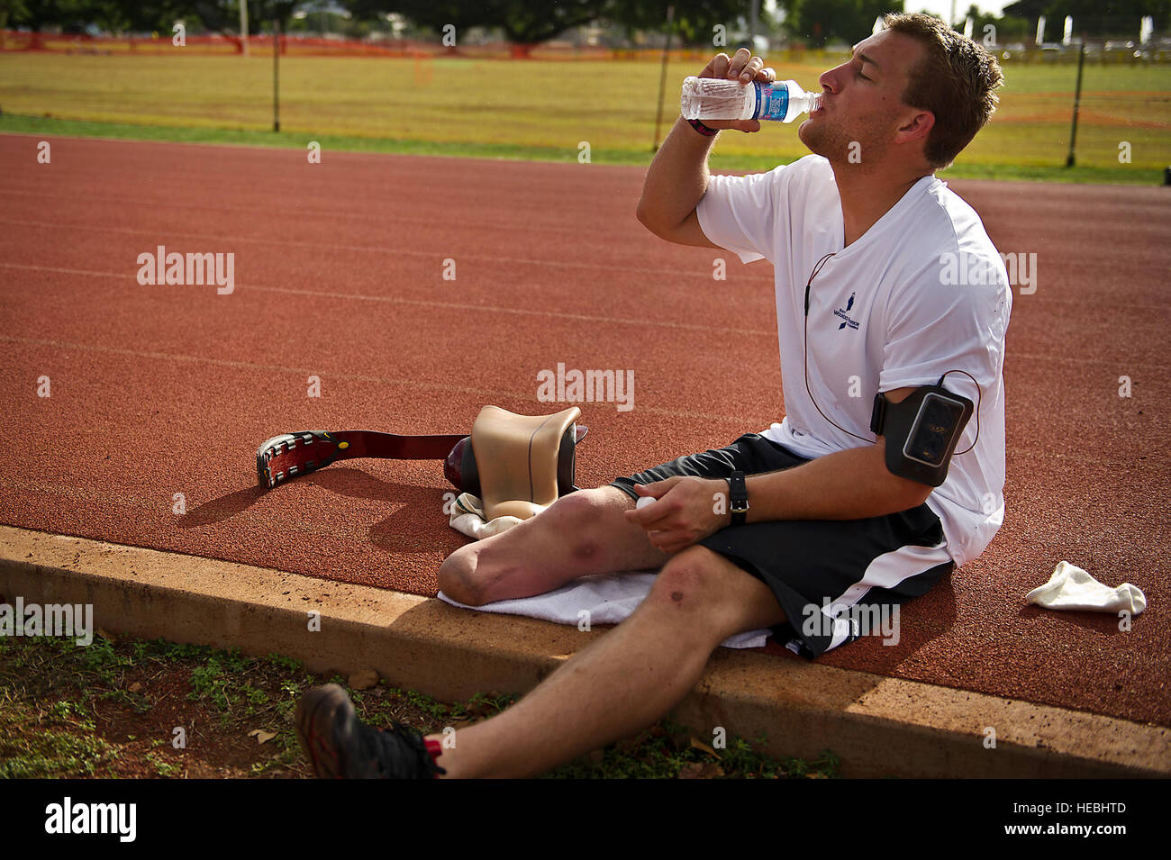 U.S. Navy Petty Officer 2nd Class Max Rohn takes a water break after ...