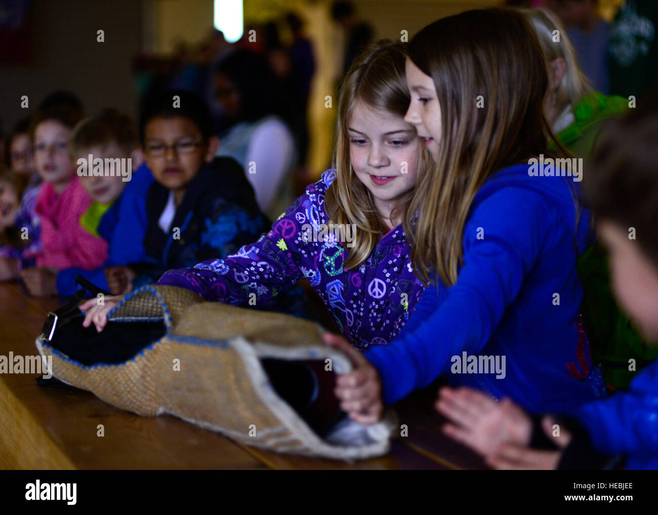 (From left) Hannah Gruenes and Camryn Wilmes look at a bite sleeve used ...