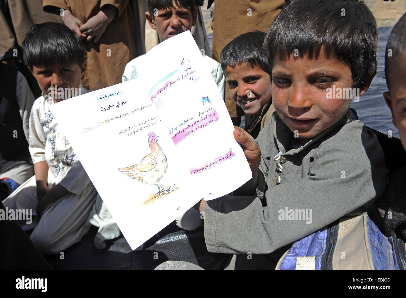 A young boy from Daychopan district shows off his school book as Zabul ...