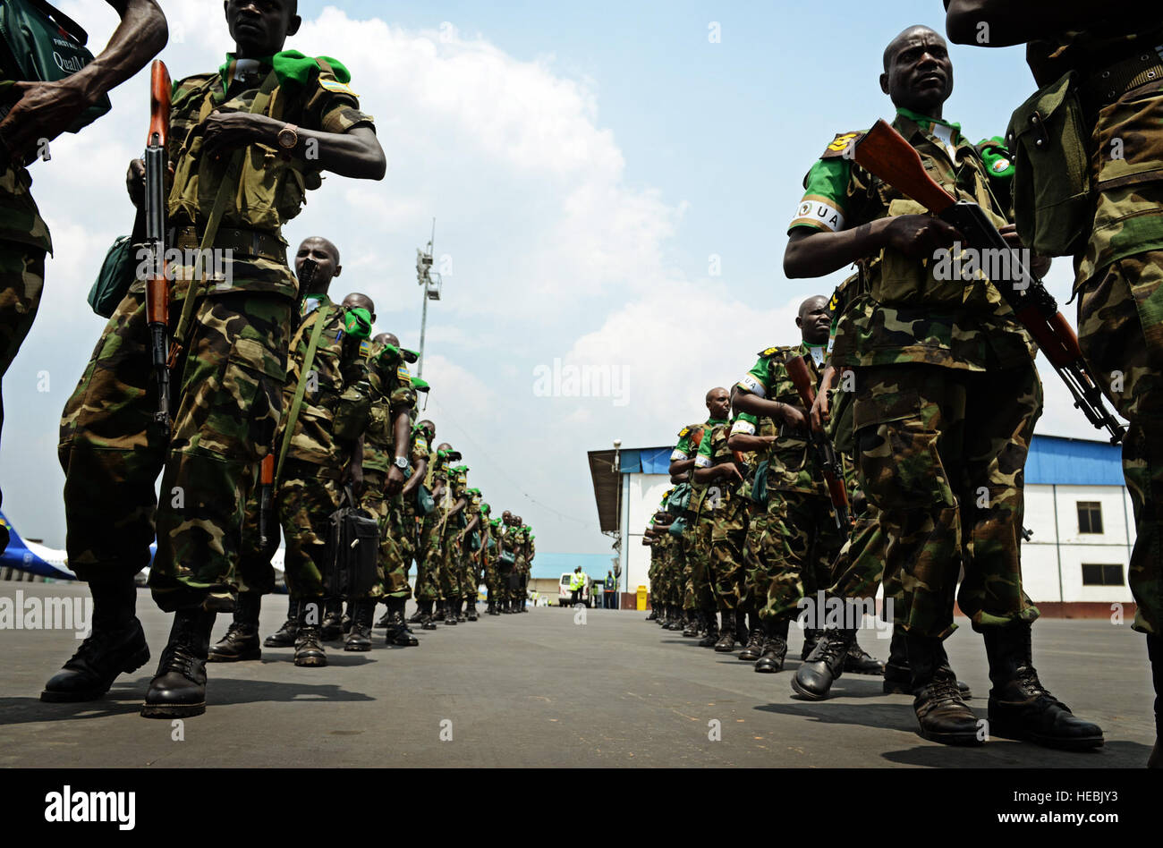 Rwandan soldiers wait in line to board a U.S. Air Force C-17 ...