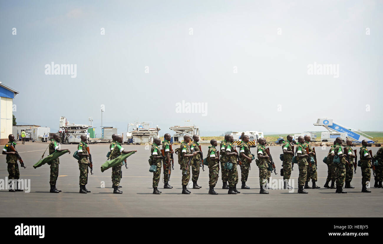 Rwandan soldiers wait in line to board a U.S. Air Force C-17 ...