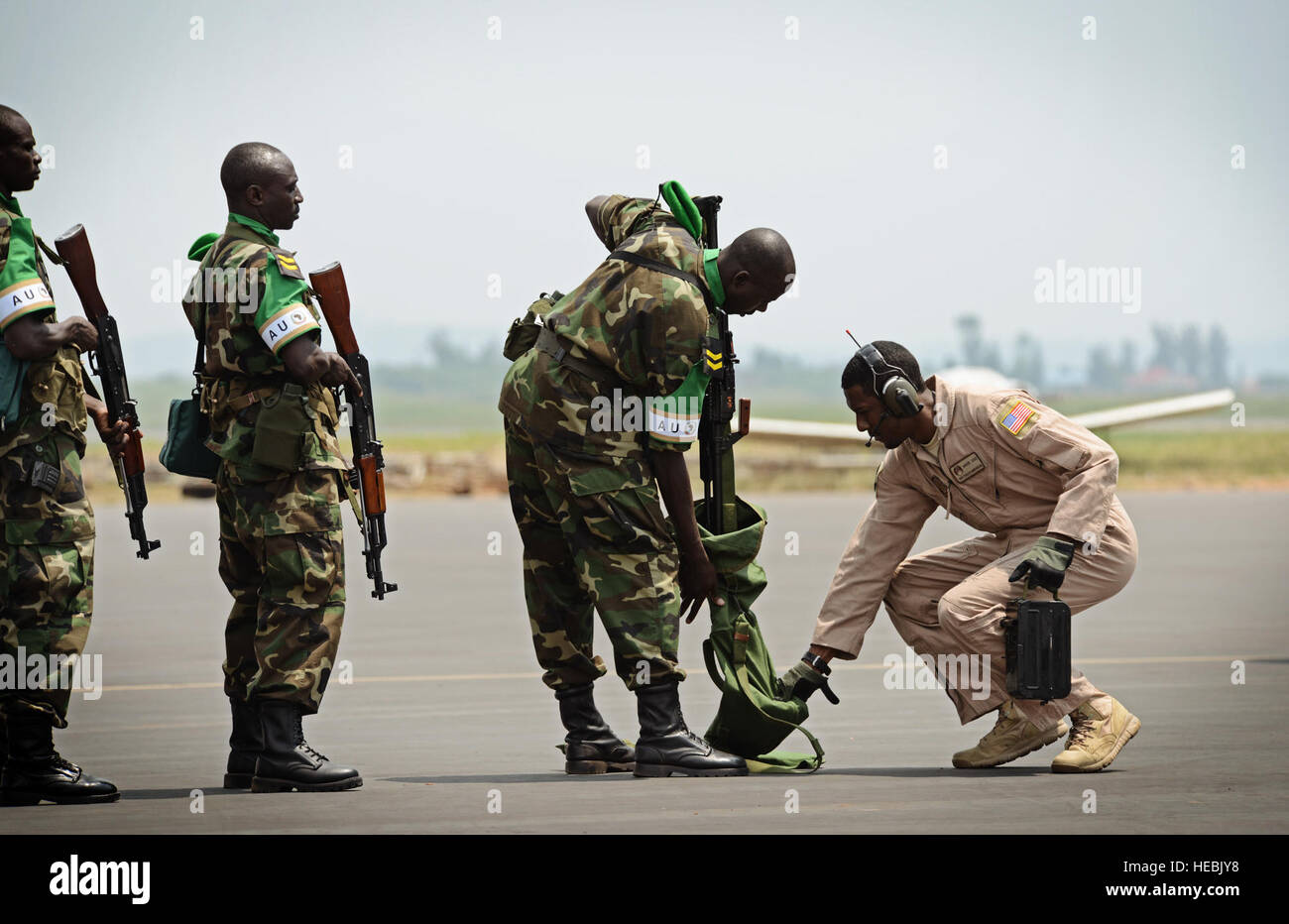 Rwandan soldiers wait in line to have their weapons inspected by U.S ...