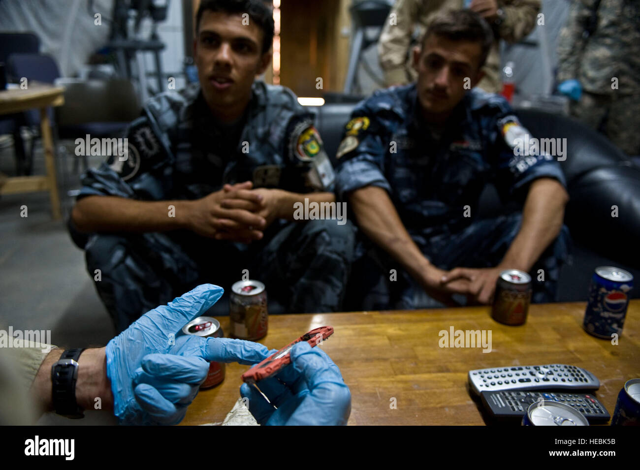Iraqi explosive ordinance disposal policemen listen as U.S. Navy Petty ...