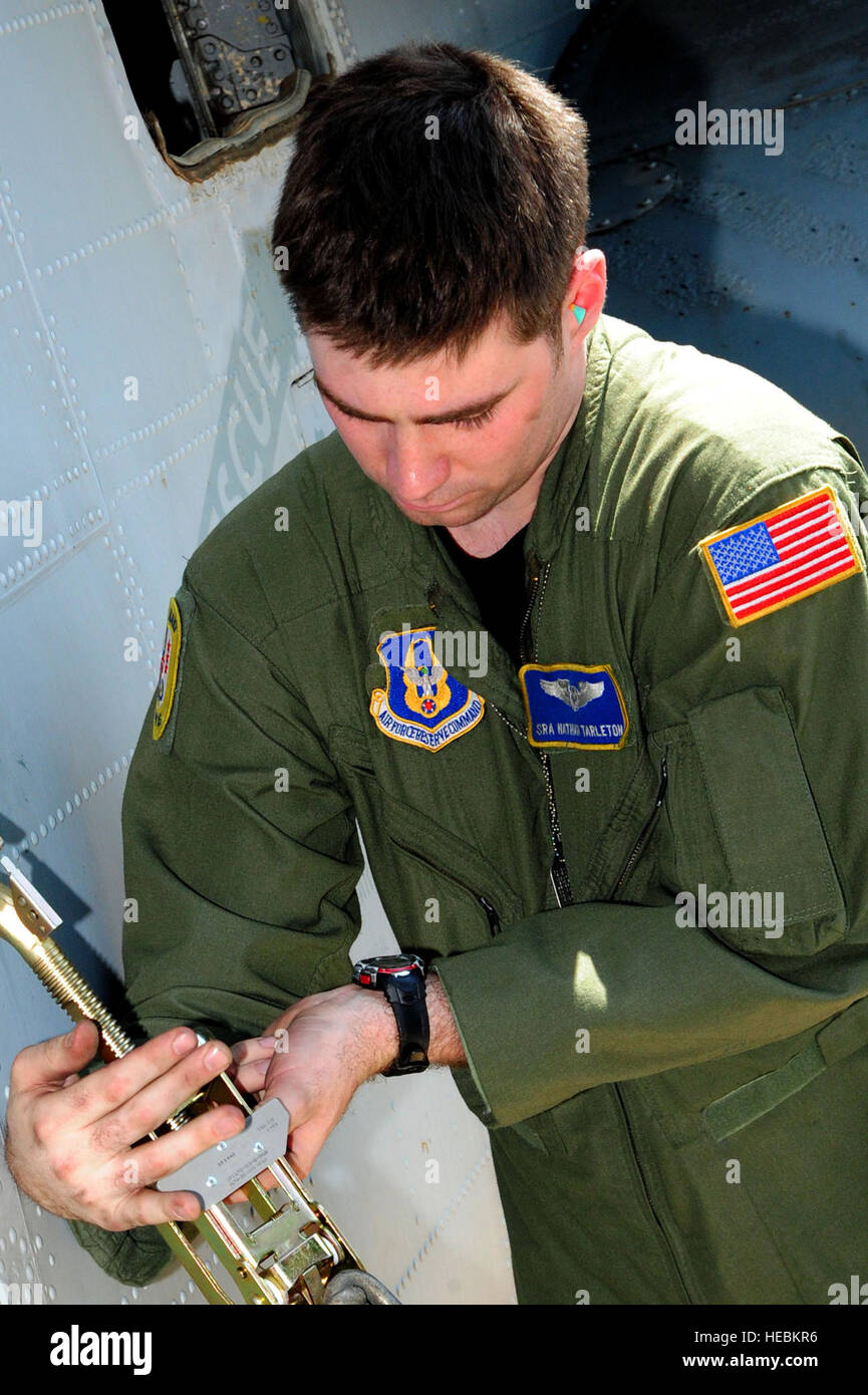 U.S. Air Force Senior Airman Nathan Tarleton secures the chain on a ...