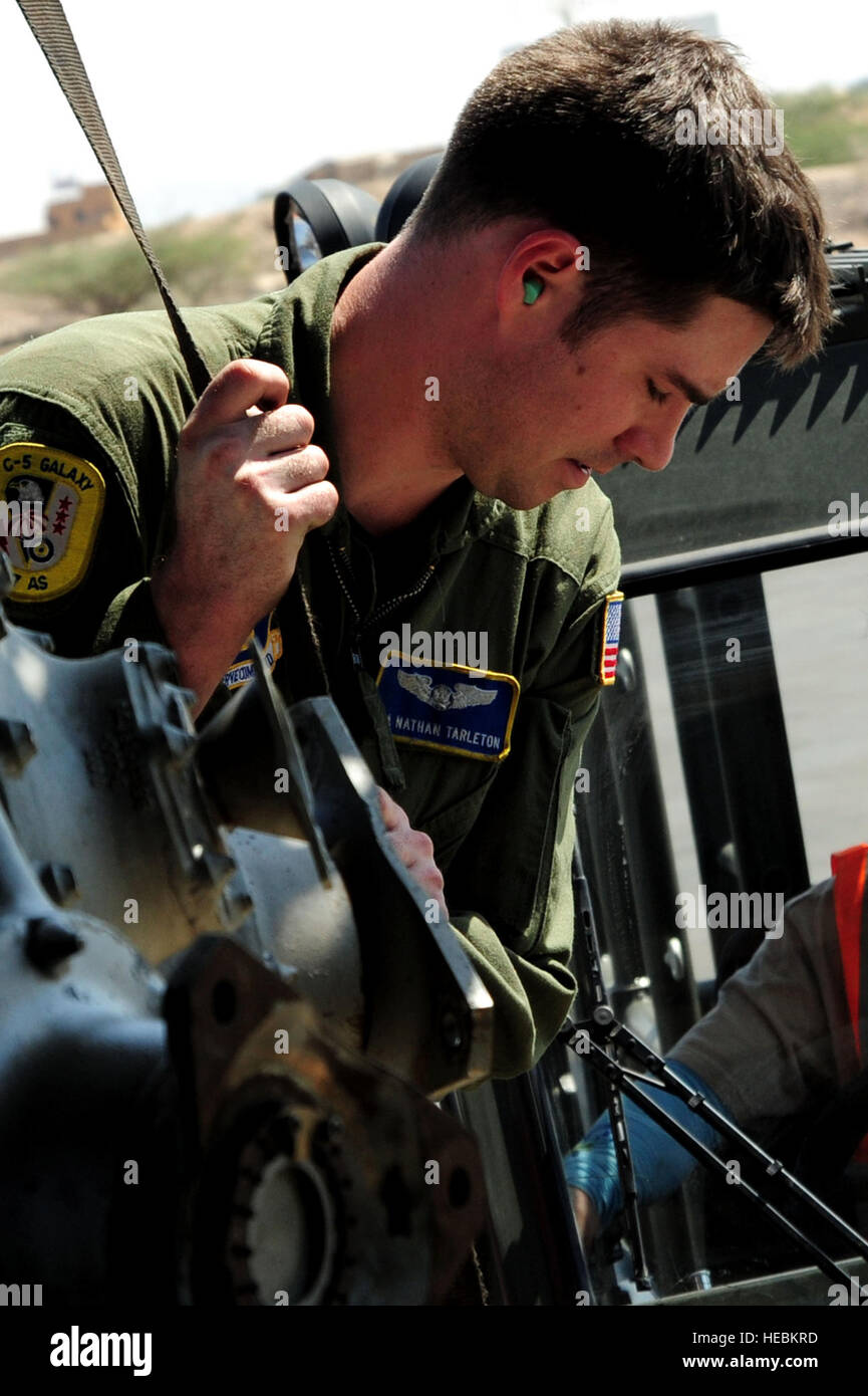 U.S. Air Force Senior Airman Nathan Tarleton pushes a pallet with ...