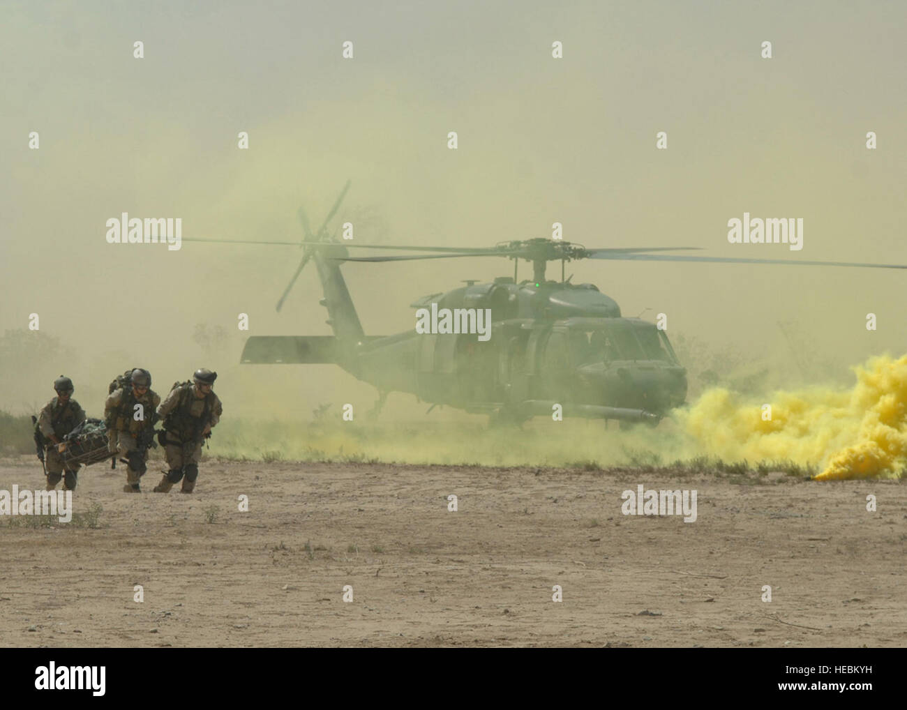 U.S. Air Force pararescuemen carry a simulated casualty on a litter ...