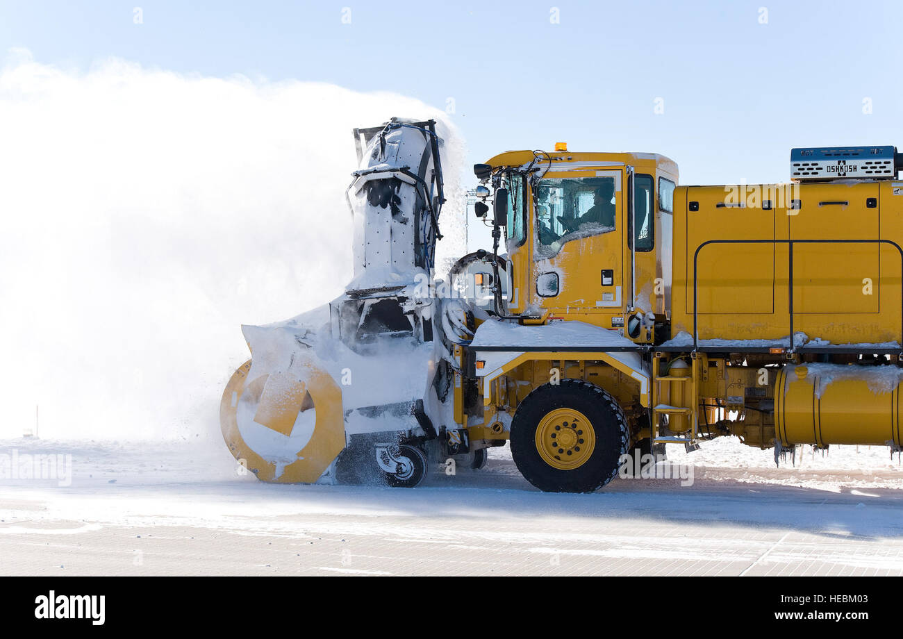 A snow blower from the 436th Civil Engineer Squadron blows snow off the ...