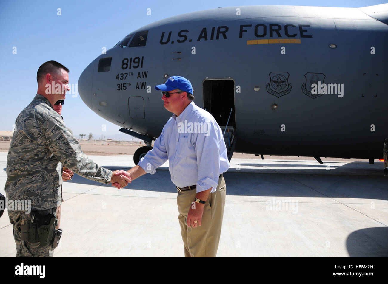 Secretary of the Air Force Michael Donley shakes hands with Col. John ...
