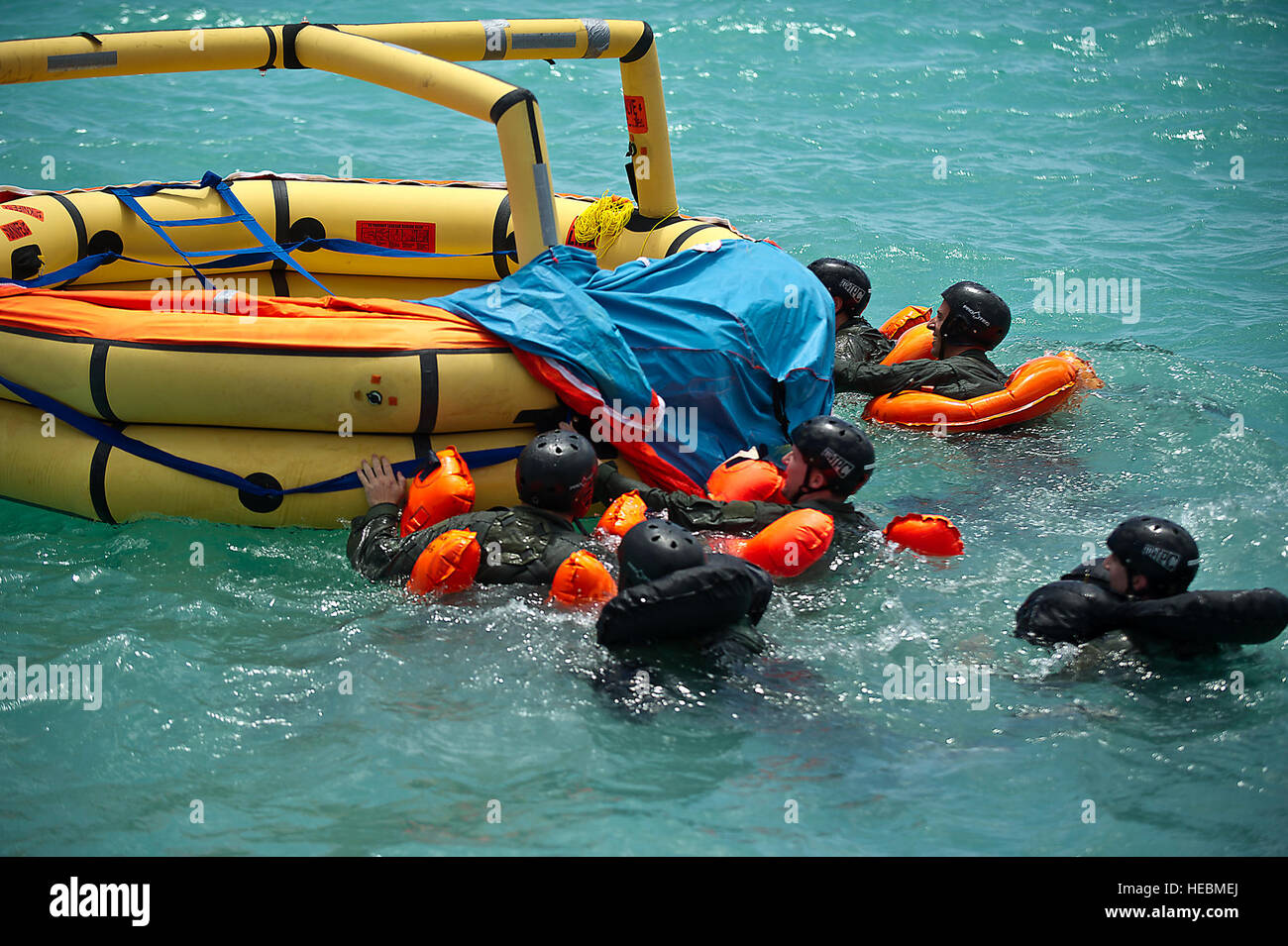 U.S. Air Force aircrew members swim toward a 13 person life raft during a water survival ...