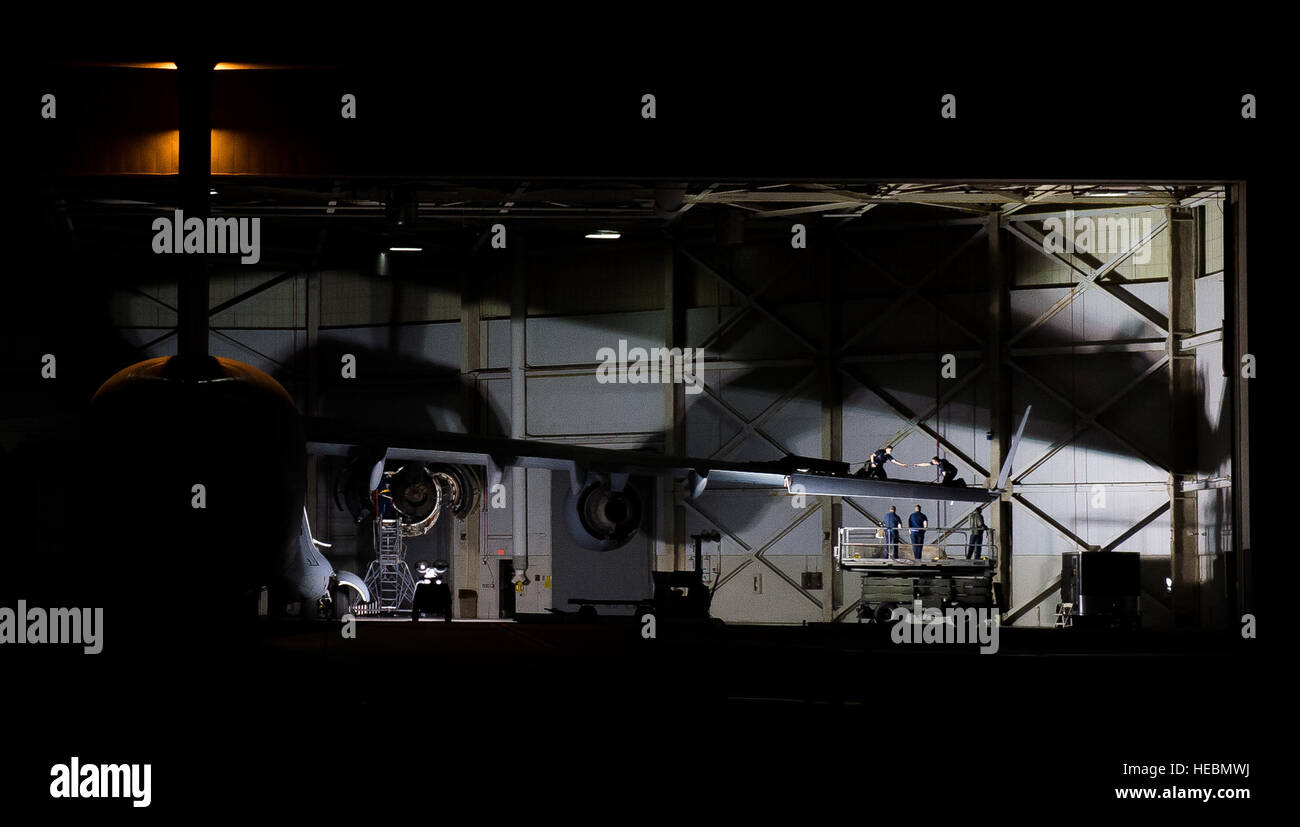 Airmen from the 437th Aircraft Maintenance Squadron use a spotlight to ...