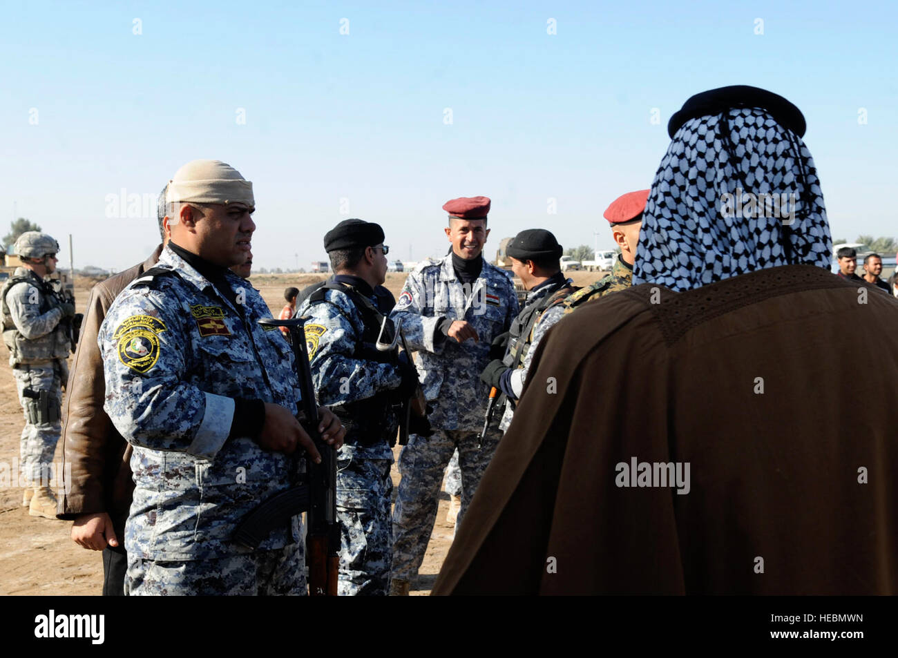 Iraqi security forces provide security for the the crowd receiving ...