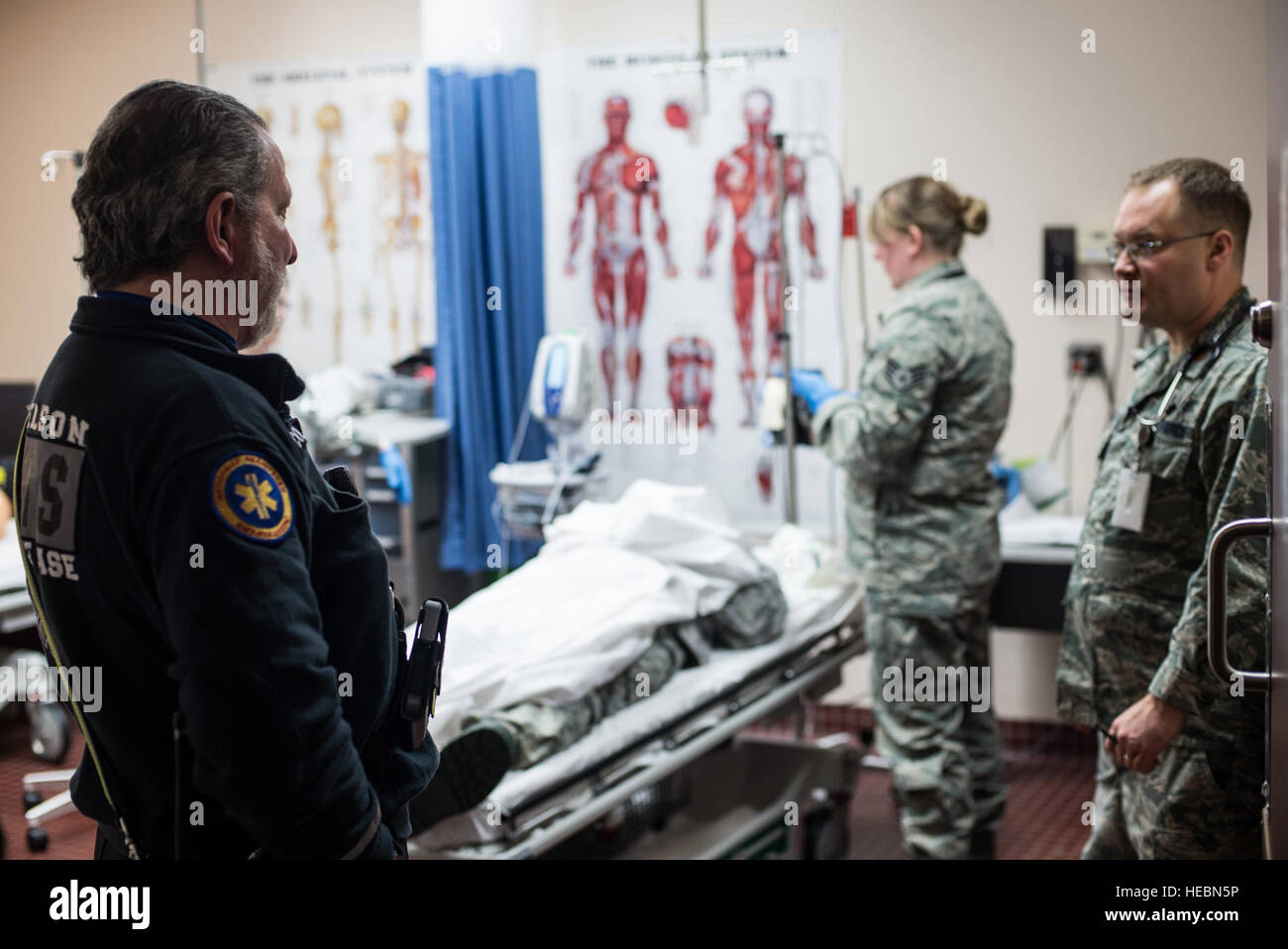 Members of the 354th Medical Group discuss a simulated casualty’s ...