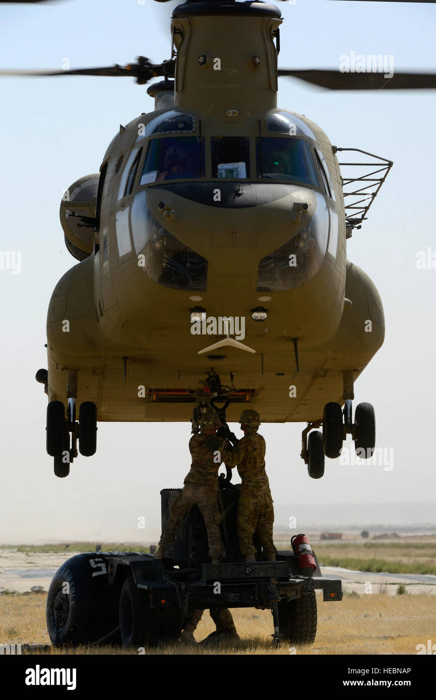 U.S. Soldiers, assigned to the 1569th Transportation Company, hook up a ...