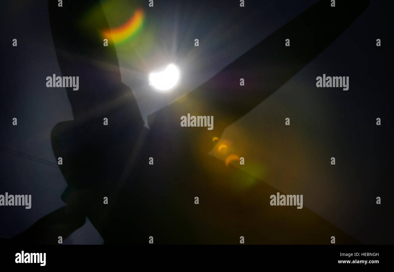 A partial solar eclipse is seen through the propeller blades of an ...