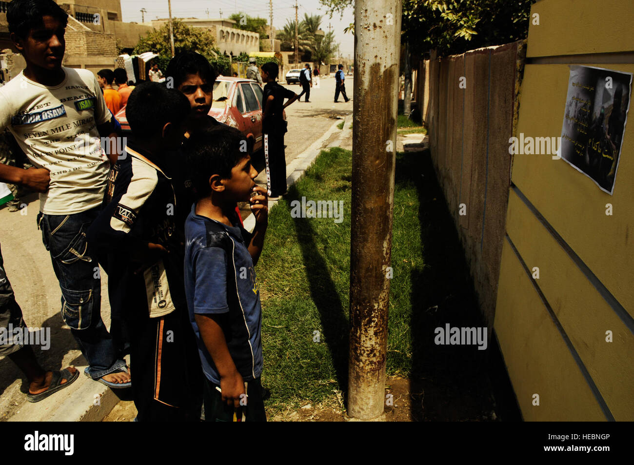 Iraqi citizens read the poster posted by Ghazaliyah patrol police ...