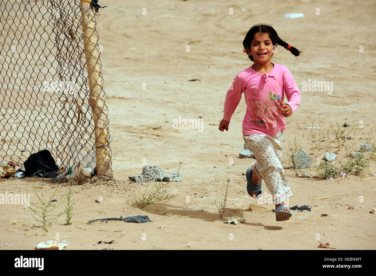 An Iraqi girl runs towards U.S. Army Soldiers from the 25th Special ...