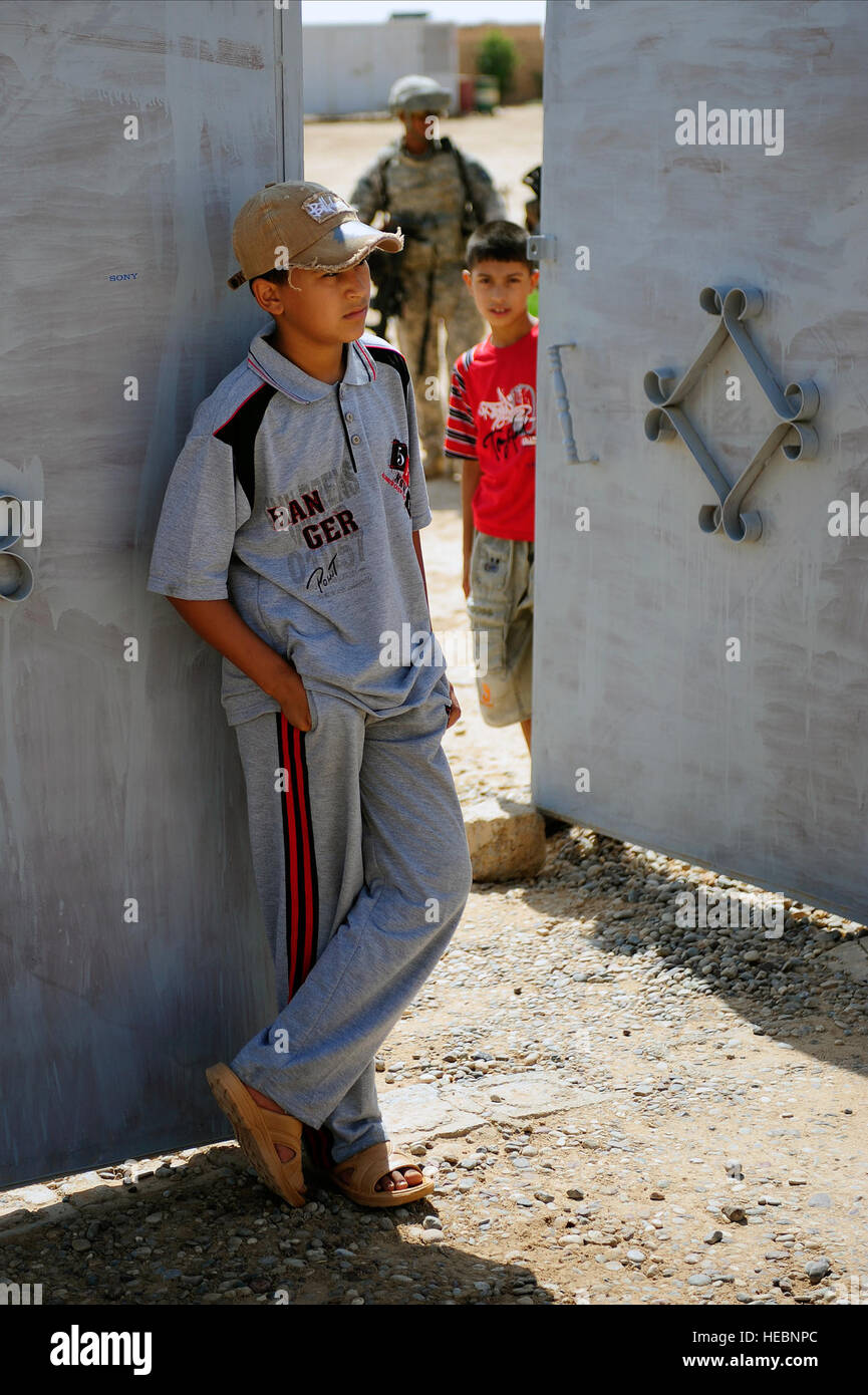 An Iraqi boy watches U.S. Soldiers from the 25th Special Troops ...