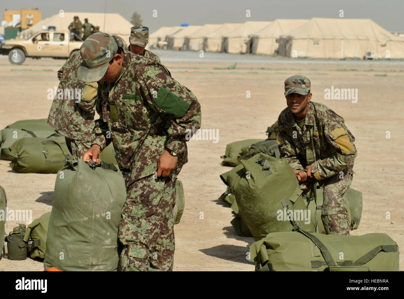 Afghan National Army soldiers pick up their bags after a combined ...