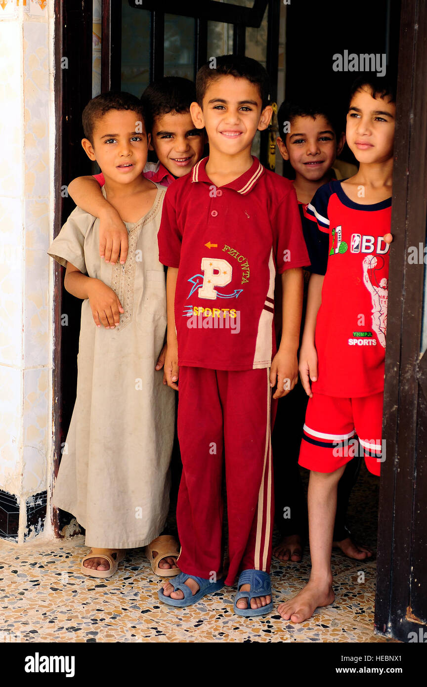 Iraqi boys watch from a doorway as U.S. Soldiers from Security ...