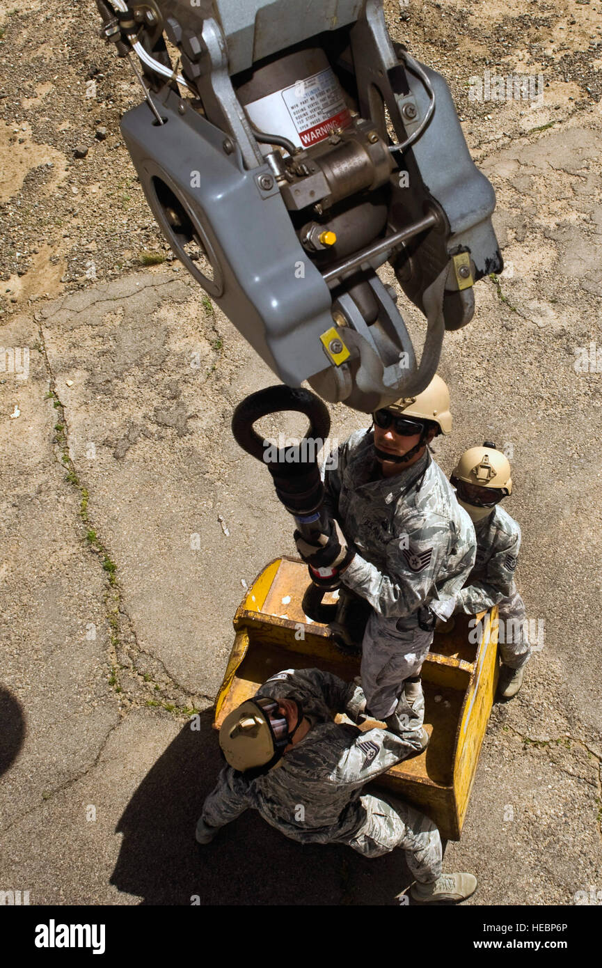 U.S. Air Force Staff Sgt. Jeremy Lowe rigs a 11,000 pound steel ...