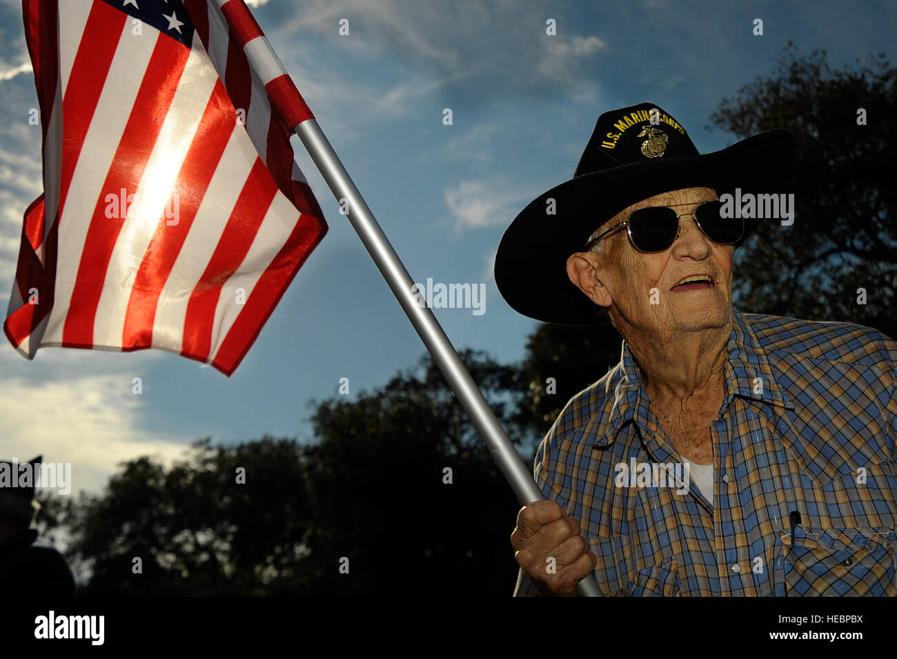 Retired U.S. Marine Lt. Col. Daniel W. Hall Jr. waves an American flag ...