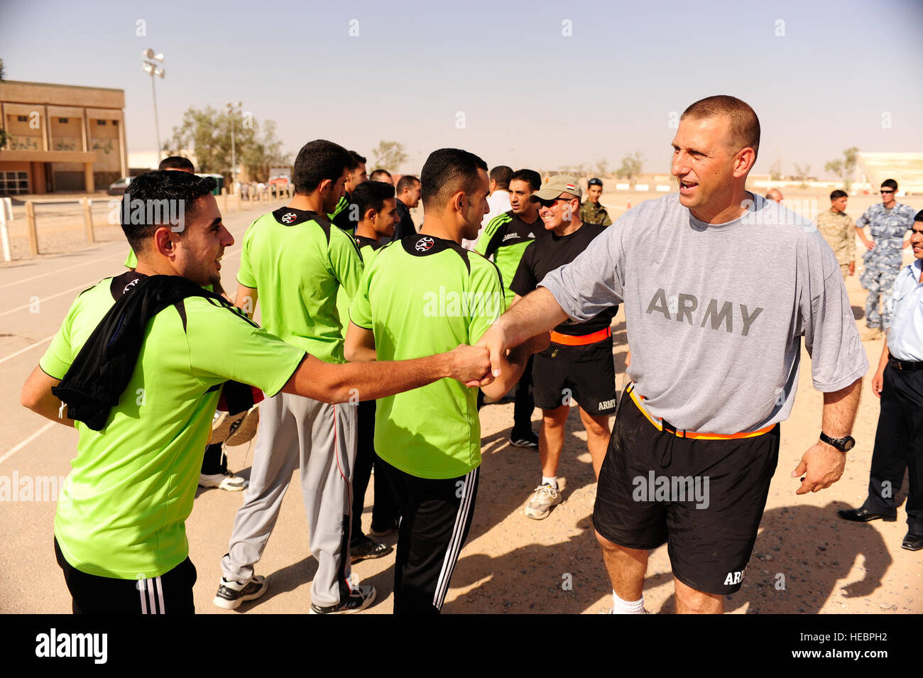 U.S. Army and Iraqi police personnel meet prior to a joint sports day ...