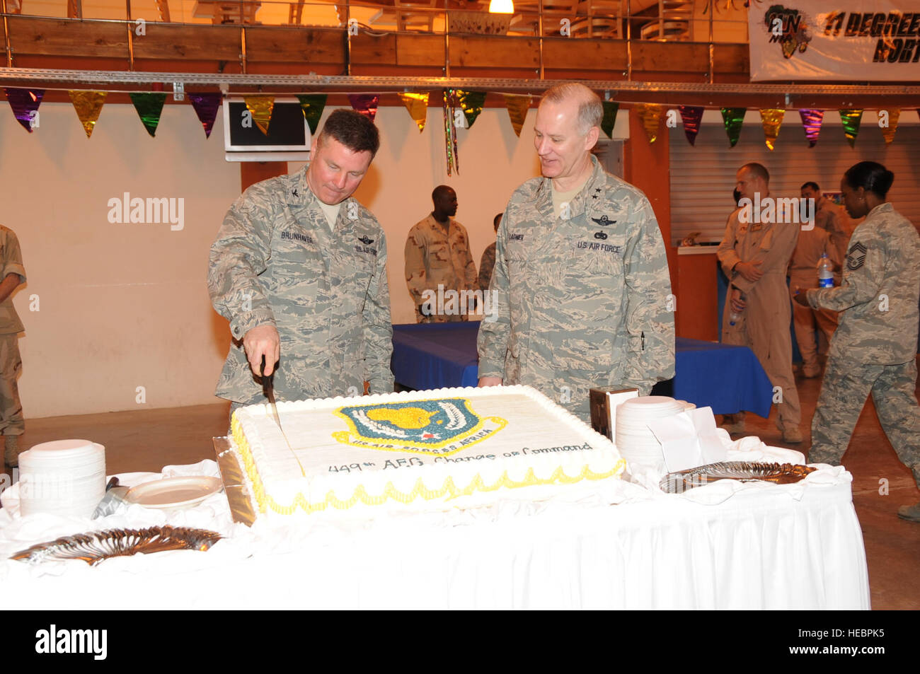 U.S. Air Force Col. John Brunhaver cuts a cake along side Major General ...