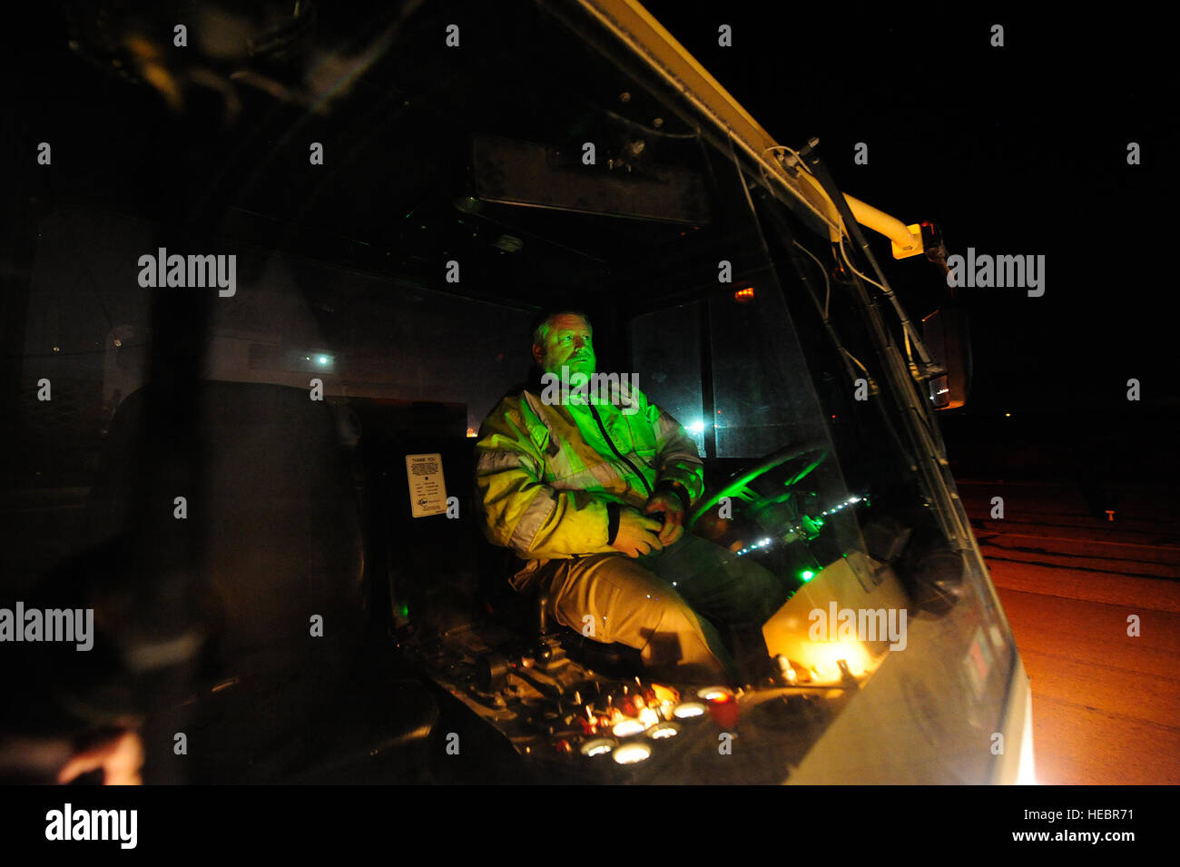 Earnest Midgett, a civilian transient alert mechanic, uses a large ...