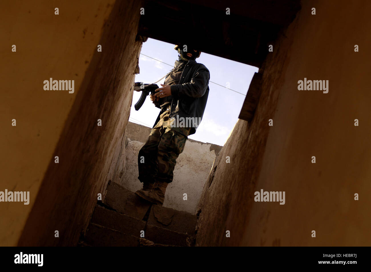 An Iraqi policeman assigned to the Emergency Services Unit checks the ...