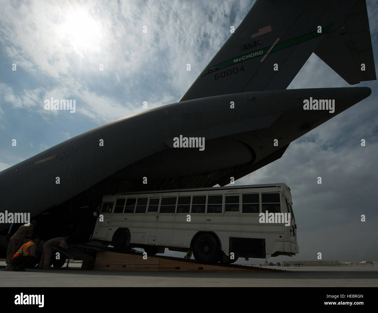 A bus is loaded onto an U.S. Air Force C-17 Globemaster III aircraft at ...