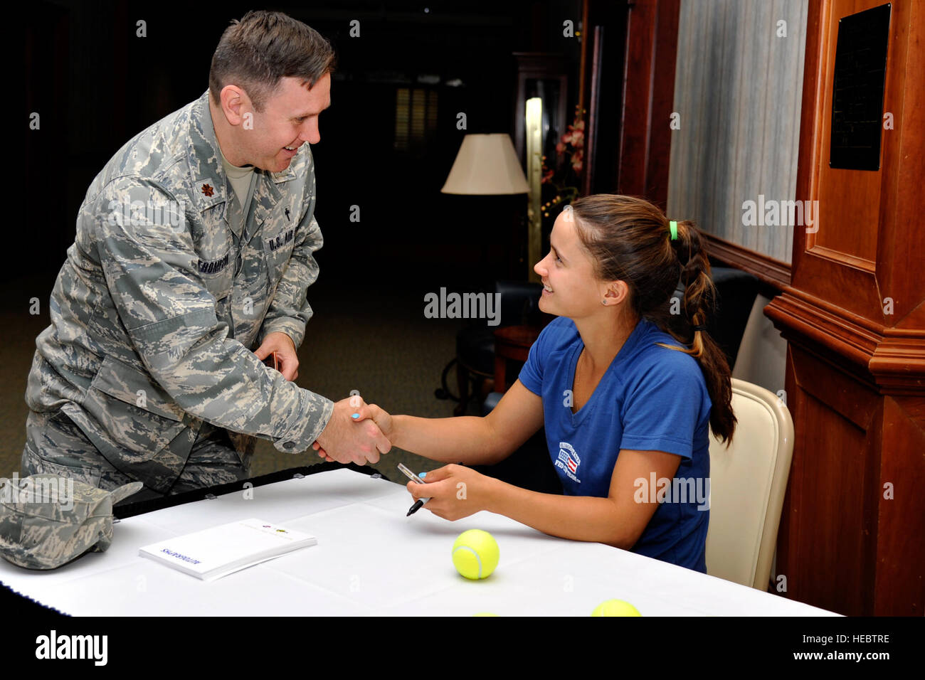 Maj. Daniel Thompson, 628th Air Base Wing Chaplain, gives a coin to ...