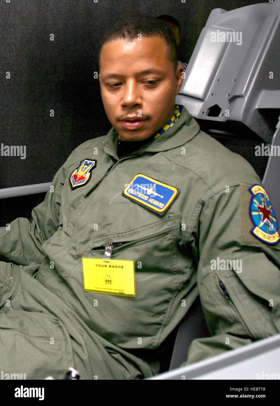 Lt. Col. David Coppler instructs actor Terrence Howard on the controls ...