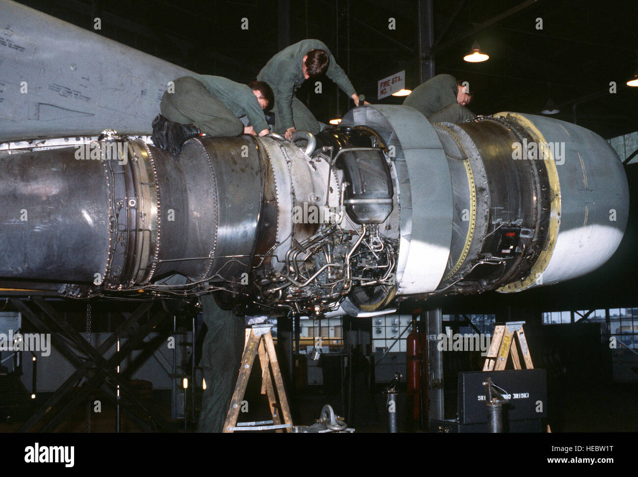 Maintenance personnel service a B-52 Stratofortress aircraft engine ...