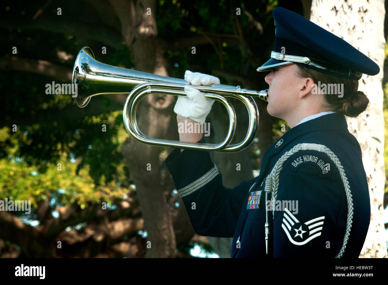 The member of the Hickam Honor Guard performs taps on a bugle during ...