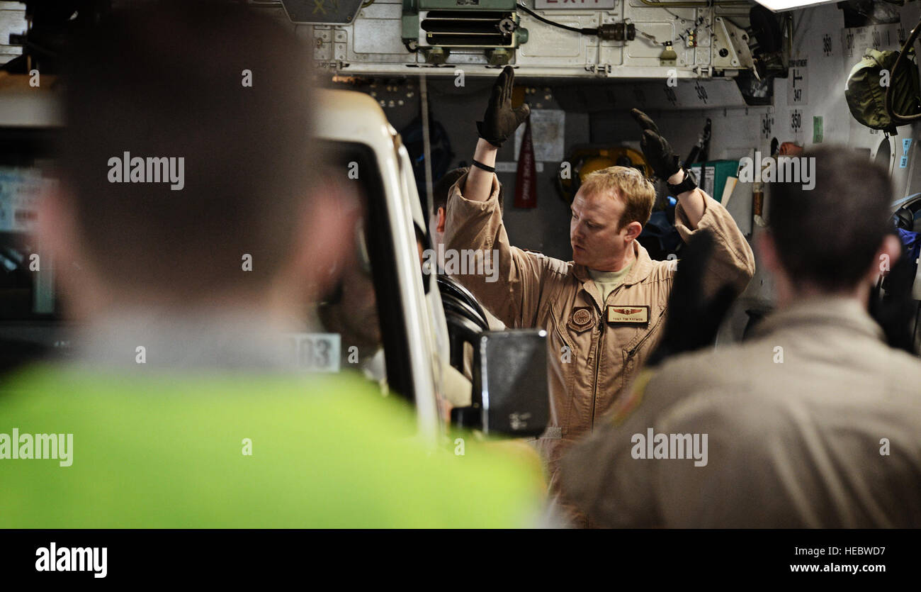 Tech. Sgt. Tim Raymon, 62nd Airlift Wing loadmaster, directs a driver into position on a C-17 ...