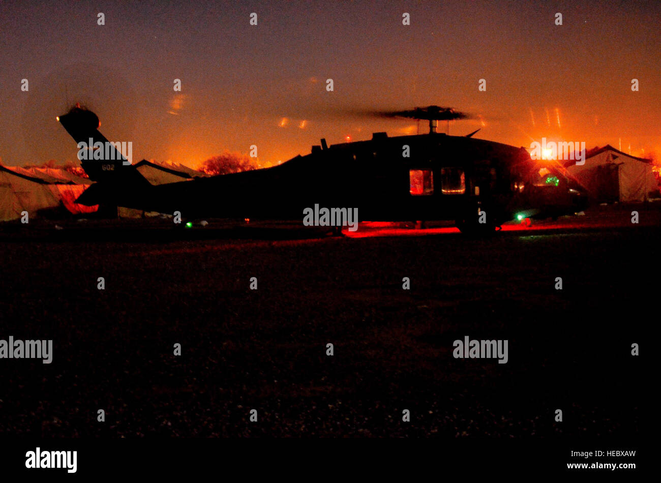 A UH-60 Black Hawk helicopter conducts refueling at a Forward Arming ...