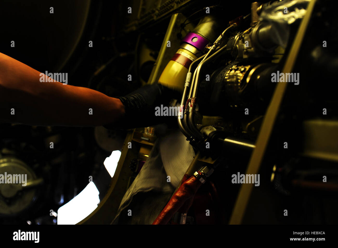 U.S. Air Force Staff Sgt. Christopher Collins wipes down a component in ...