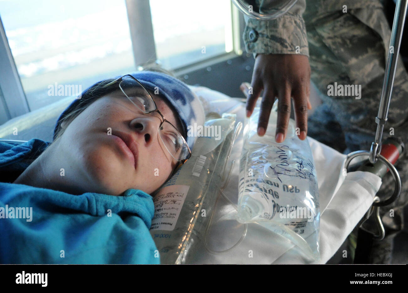 A simulated natural disaster casualty, left, looks at a U.S. Airman ...