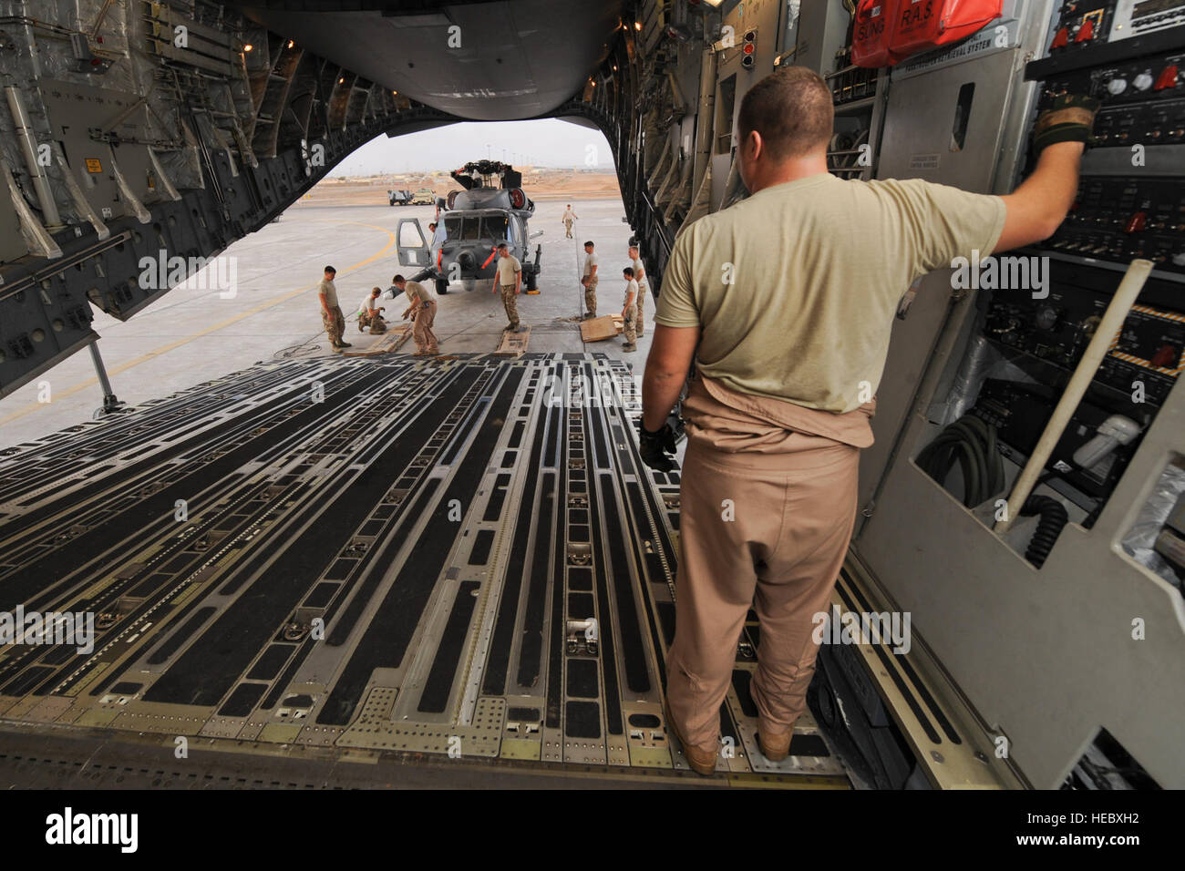 U.S. Air Force Master Sgt. Jacob Fleming, loadmaster, helps load an HH ...