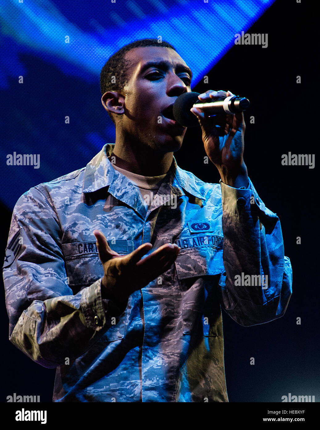 Senior Airman Rashaun Carter belts out a solo during a Fourth of July ...