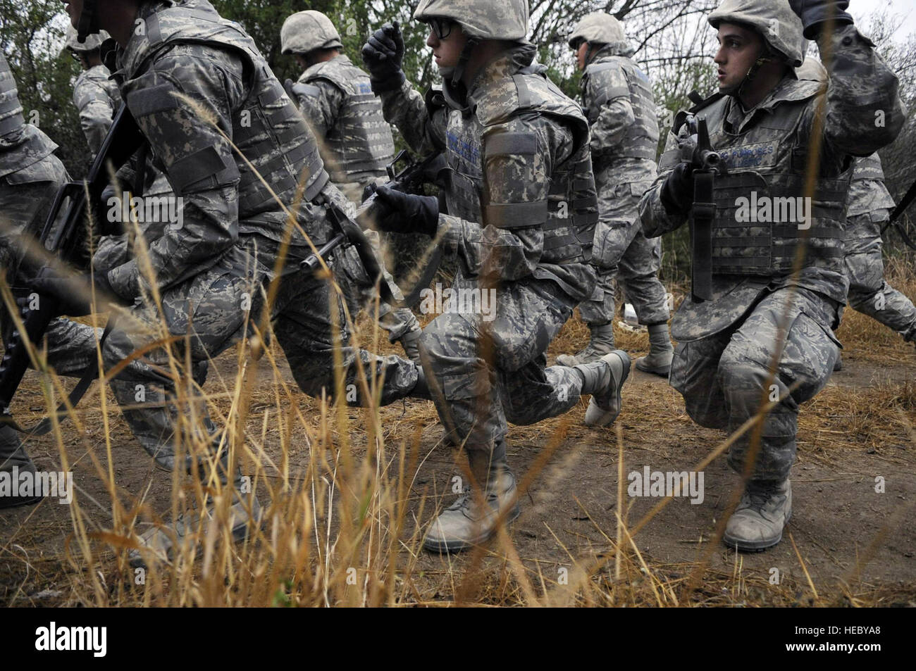 Airmen Basic trainees in body armor use hand signals as they take a ...